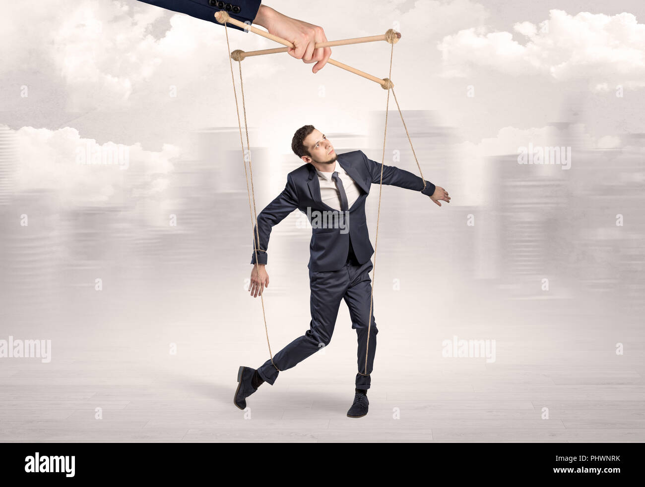 Puppet man with big city great power concept Stock Photo - Alamy