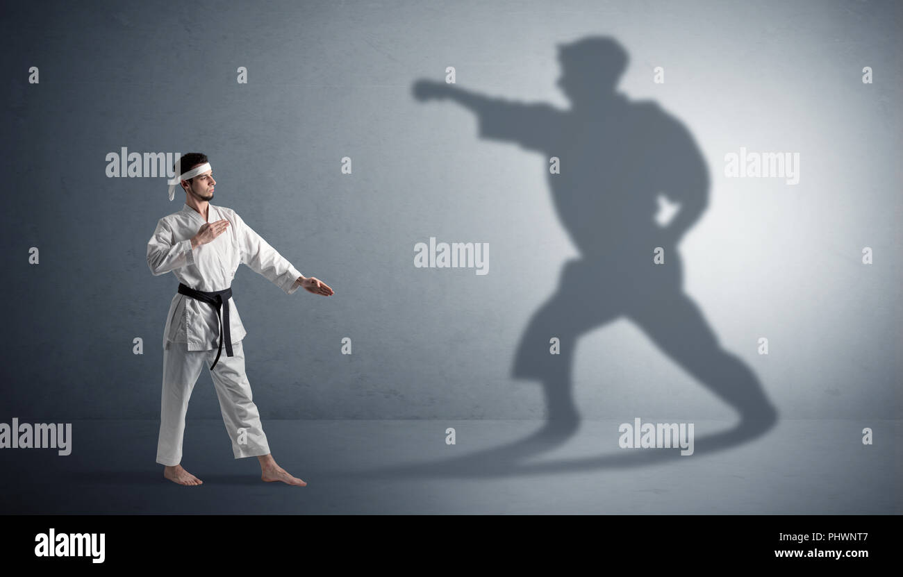 Young karate man confronting with his own shadow Stock Photo - Alamy