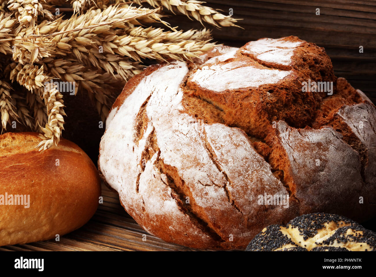 Different kinds of bread and bread rolls on board from above. Kitchen ...