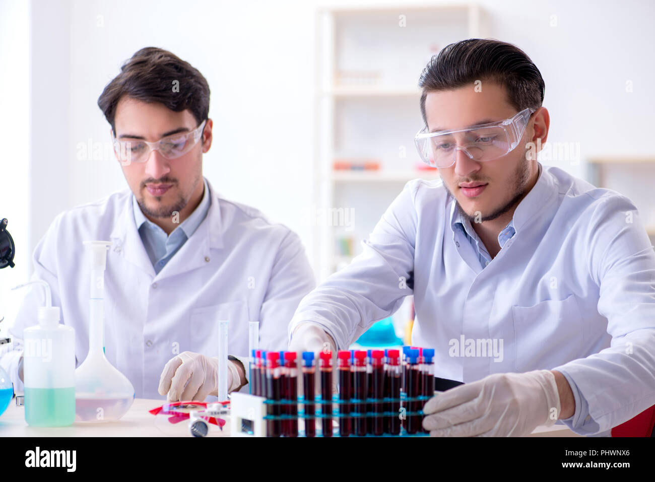 Team of chemists working in the lab Stock Photo - Alamy