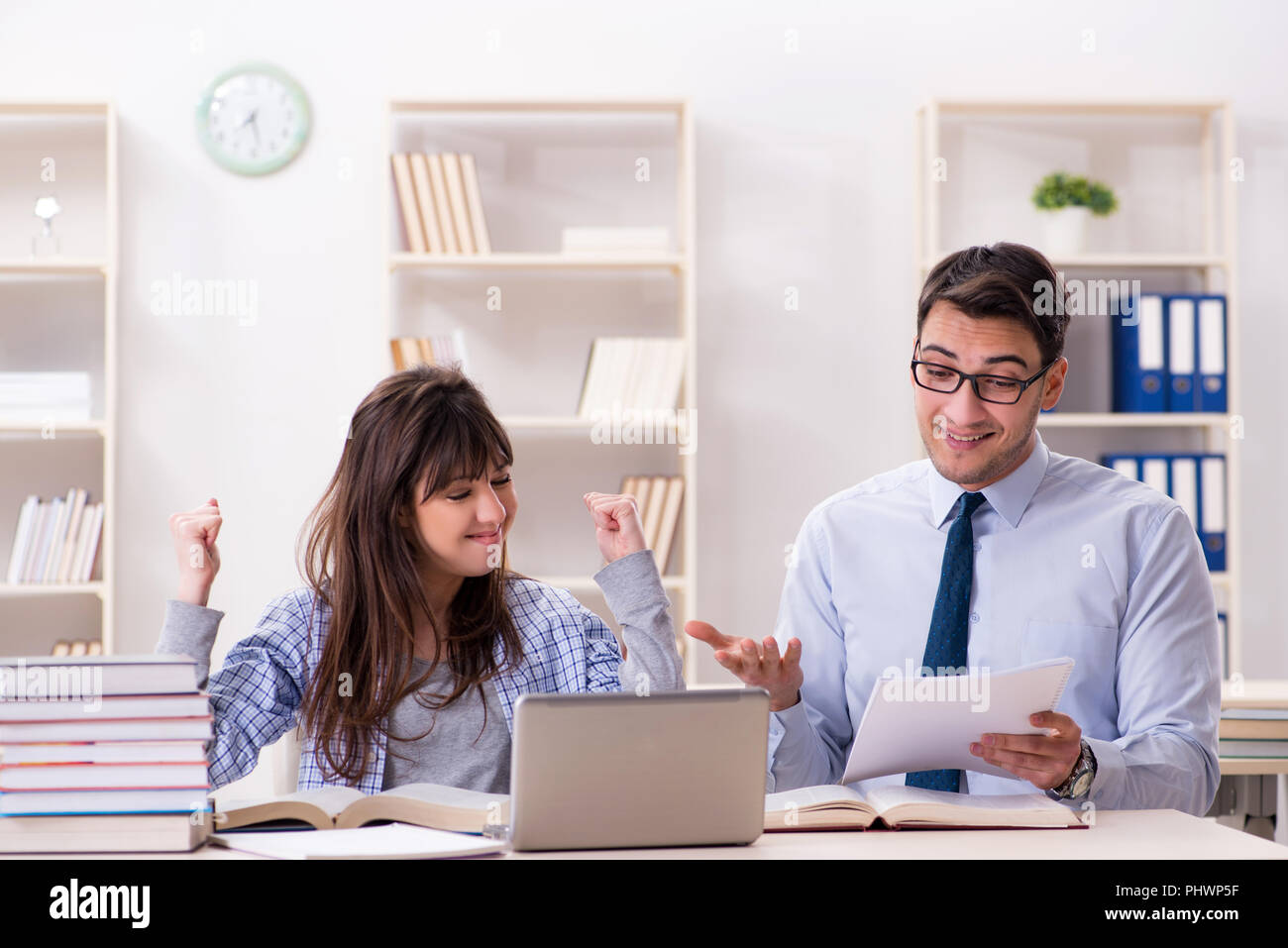 Male lecturer giving lecture to female student Stock Photo - Alamy