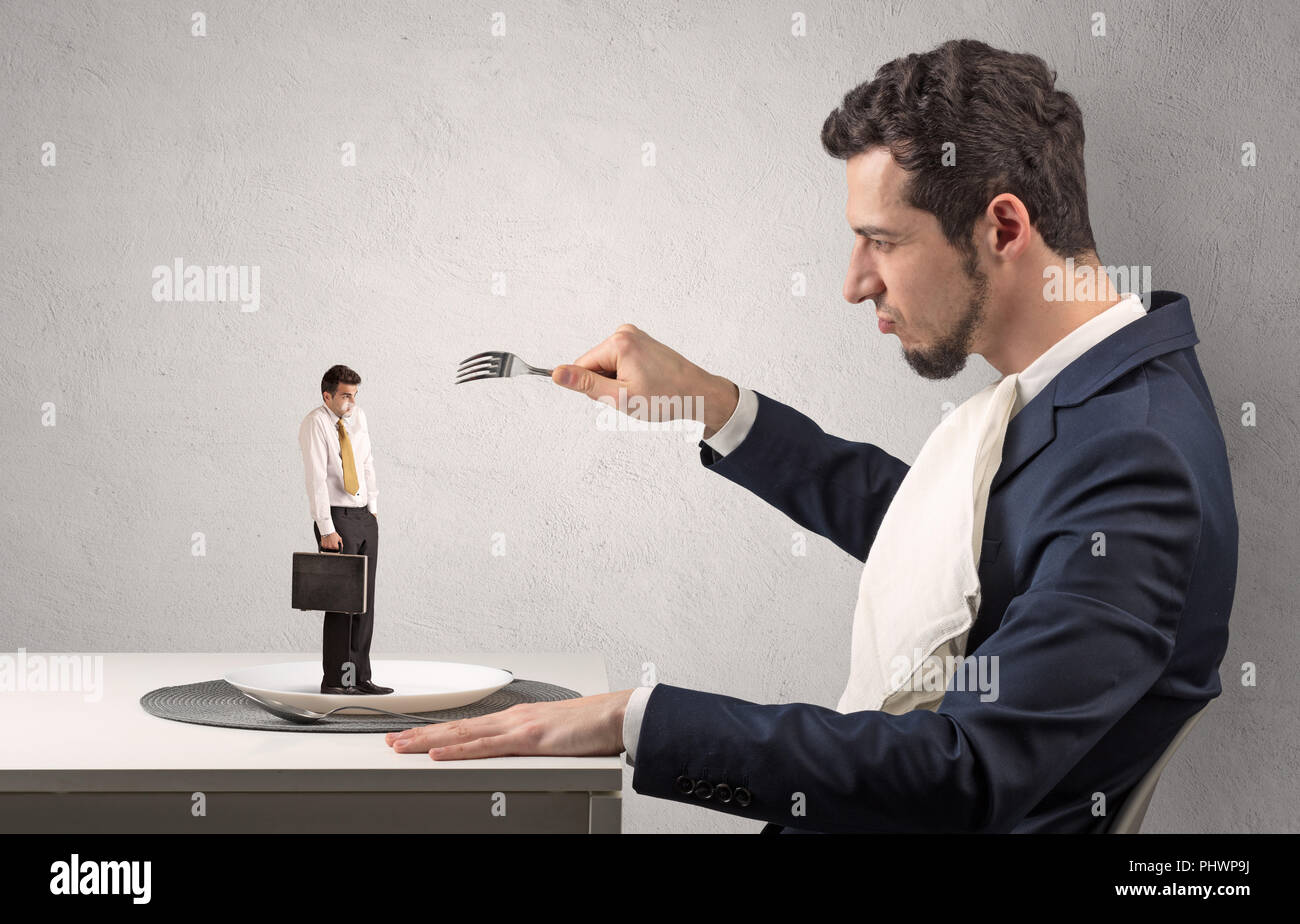 Tiny scared weak businessman almost devoured by great power Stock Photo ...