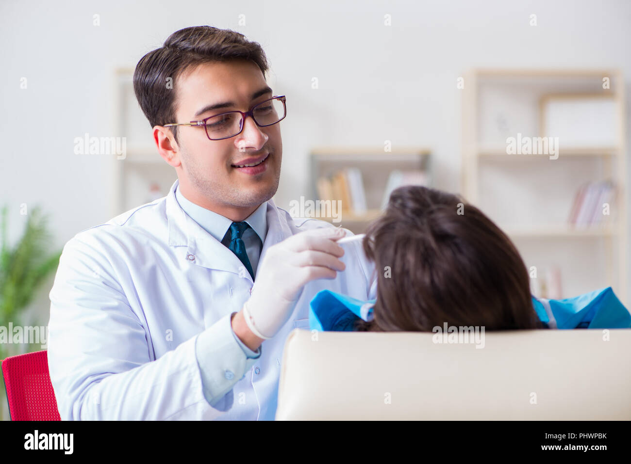 Patient visiting dentist for regular check-up and filling Stock Photo ...