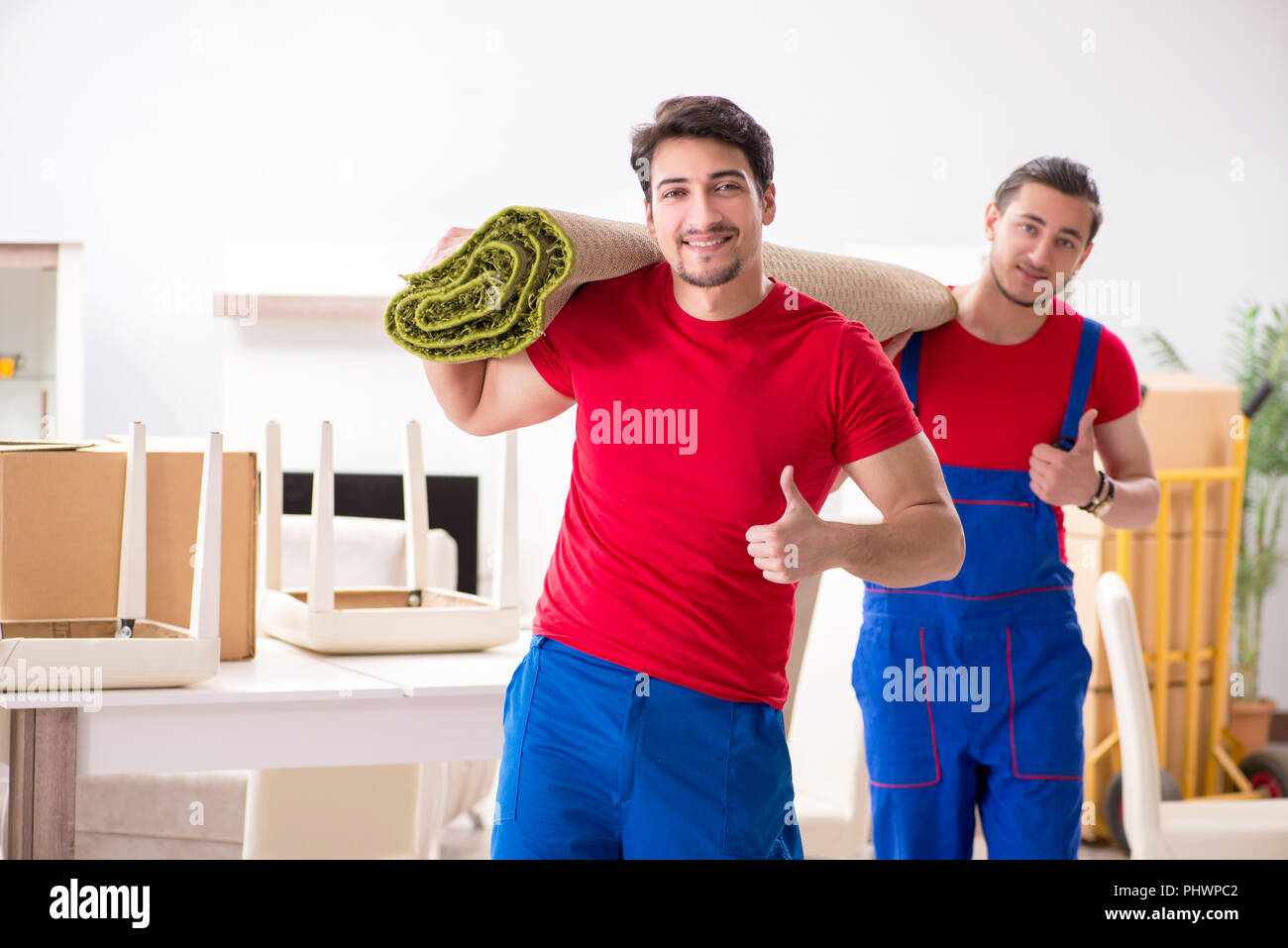 Two contractor employees moving personal belongings Stock Photo - Alamy