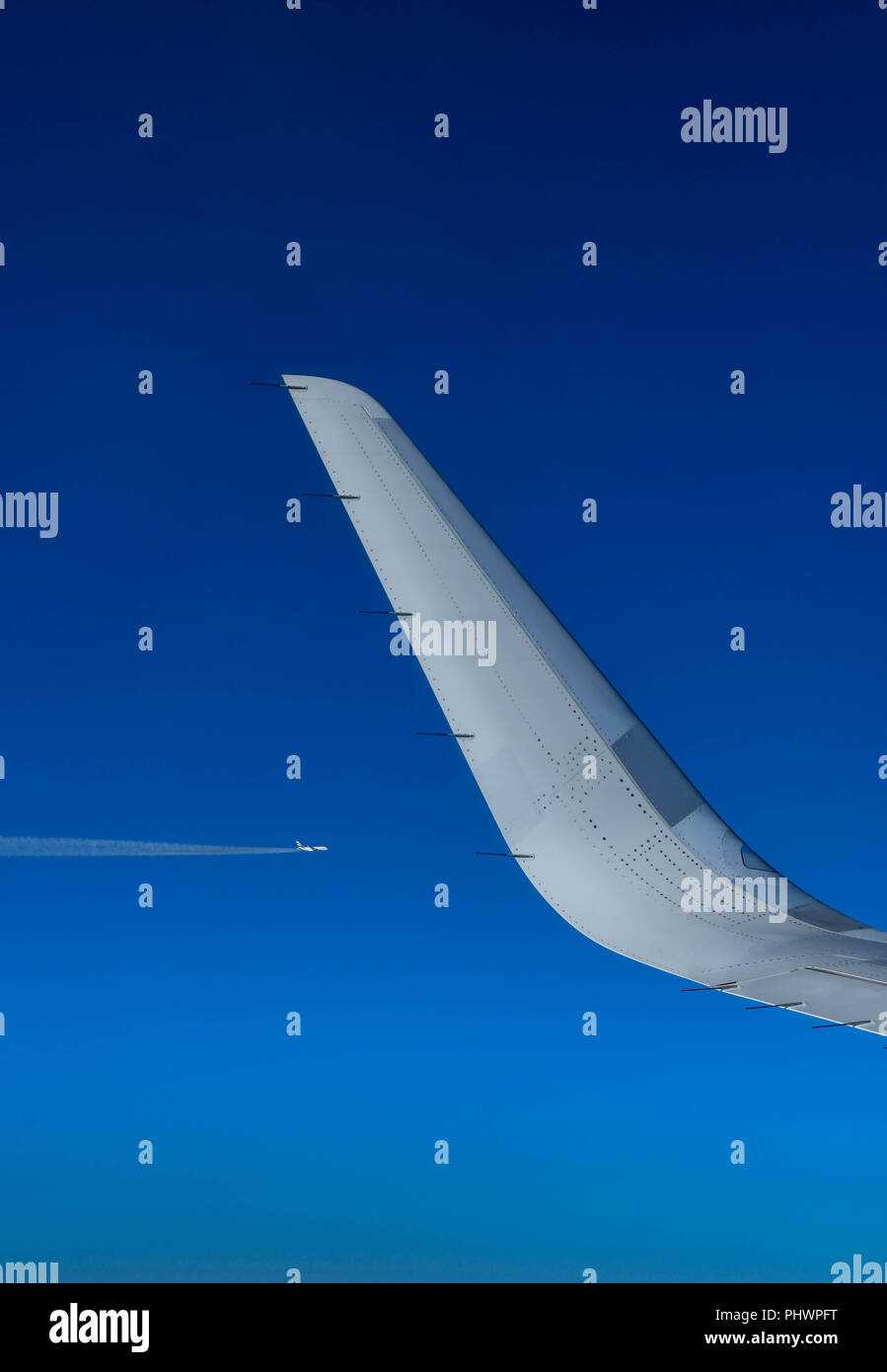 Curved wingtip, known as a “winglet”, of a modern passenger jet. In the ...