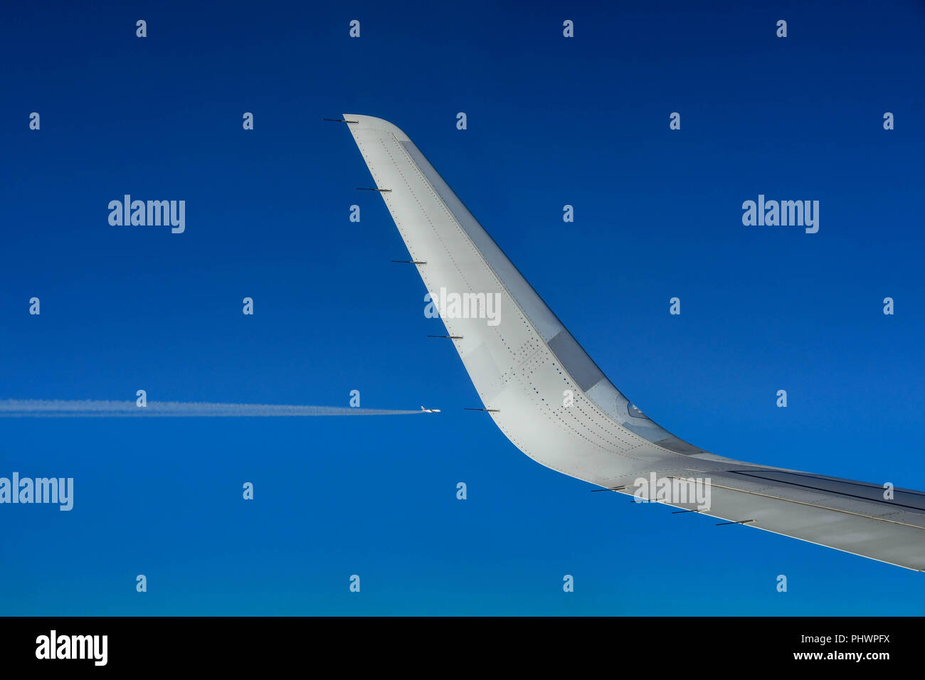 Curved wingtip, known as a “winglet”, of a modern passenger jet. In the ...