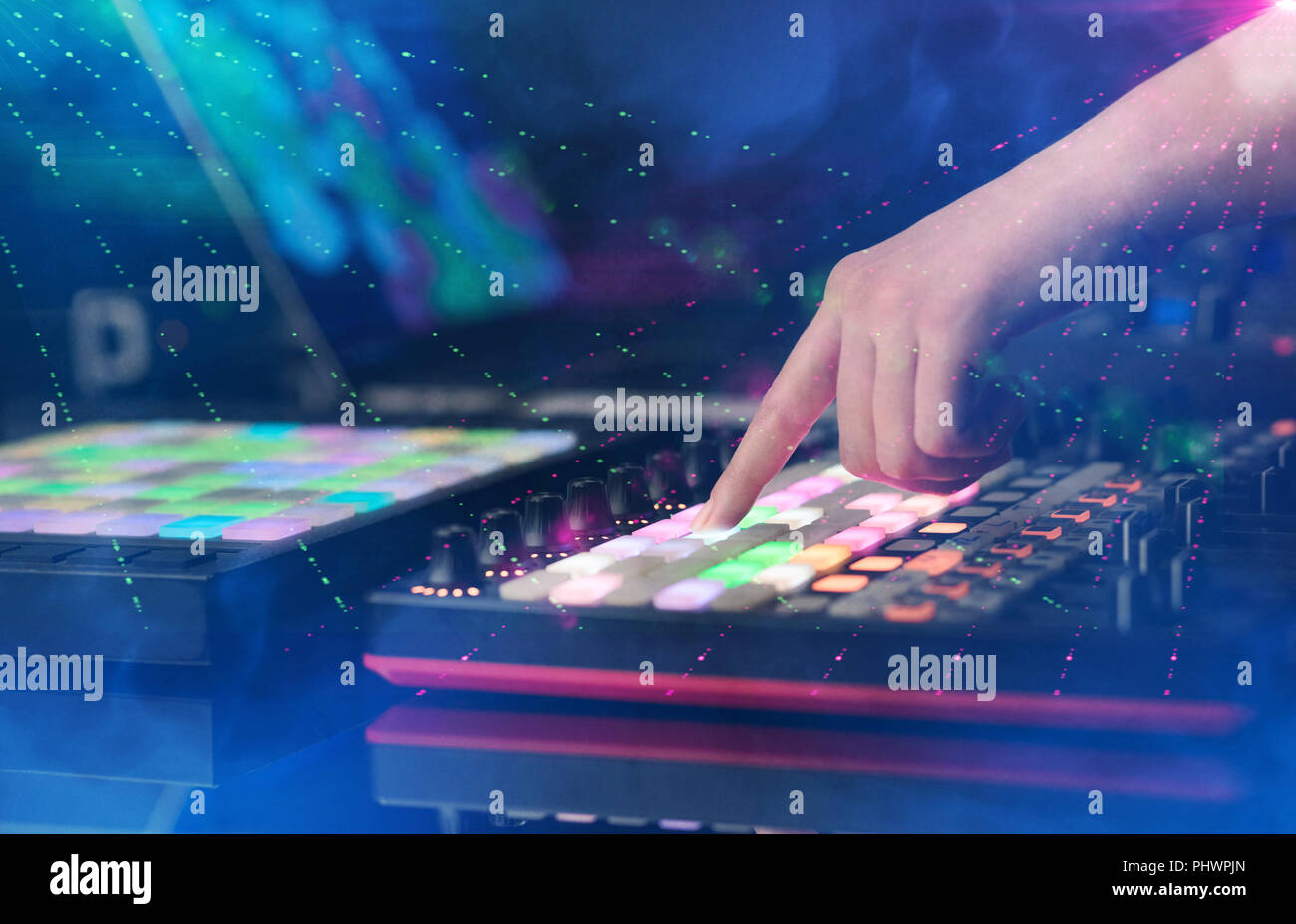 Hand mixing music on midi controller with party club colors around ...