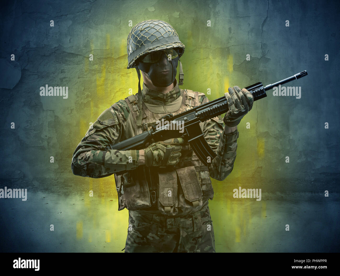 Hazard, menace soldier in a ruined crumbly building with arms on his ...