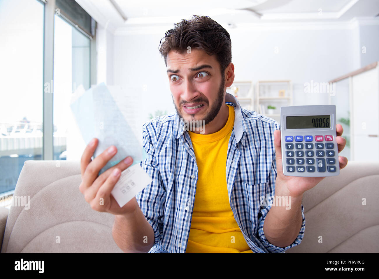 Man angry at bills he needs to pay Stock Photo - Alamy