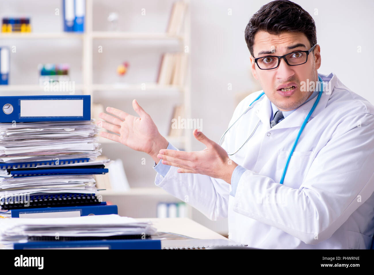 Busy doctor with too much work in hospital Stock Photo - Alamy