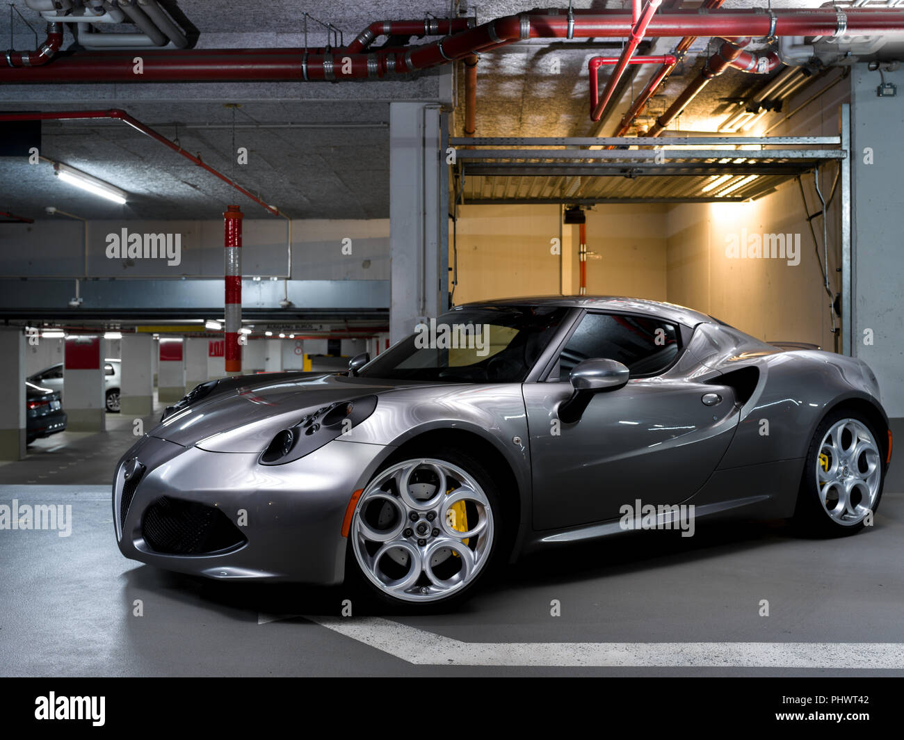 Front 3/4 angle of shiny grey super sports car in garage waiting for ...