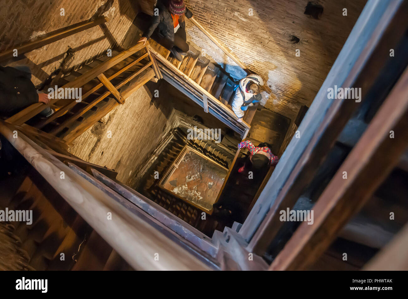 People walking down the Stairs inside of Asinelli tower, Bologna ...