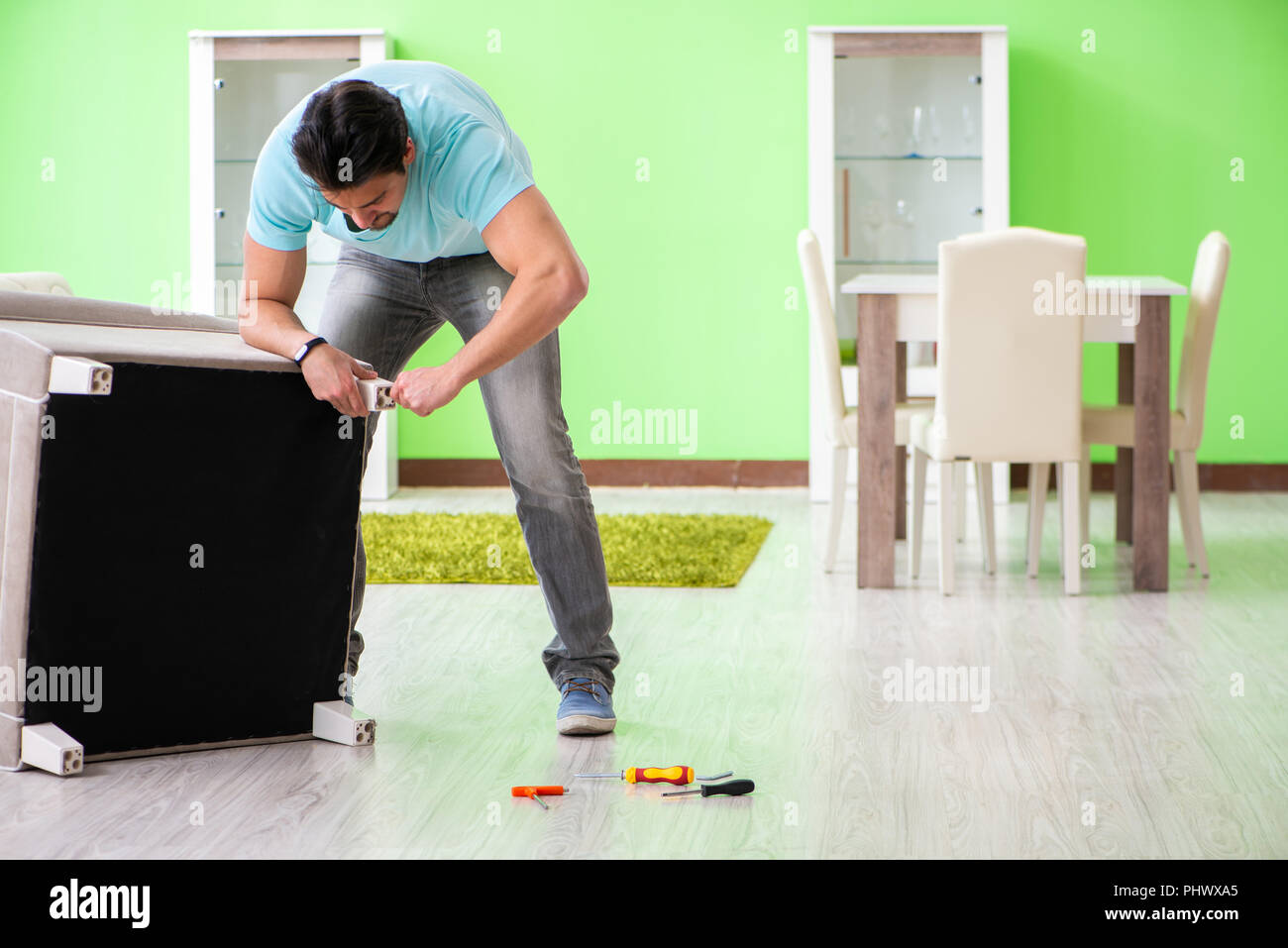 Man repairing furniture at home Stock Photo - Alamy
