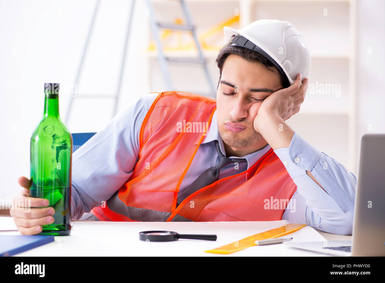 Drunk engineer working in the workshop Stock Photo - Alamy