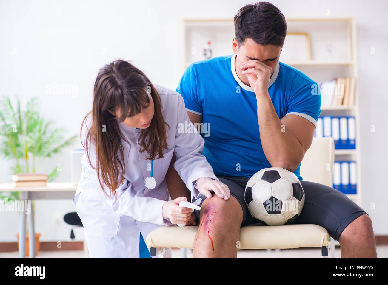 Football soccer player visiting doctor after injury Stock Photo - Alamy