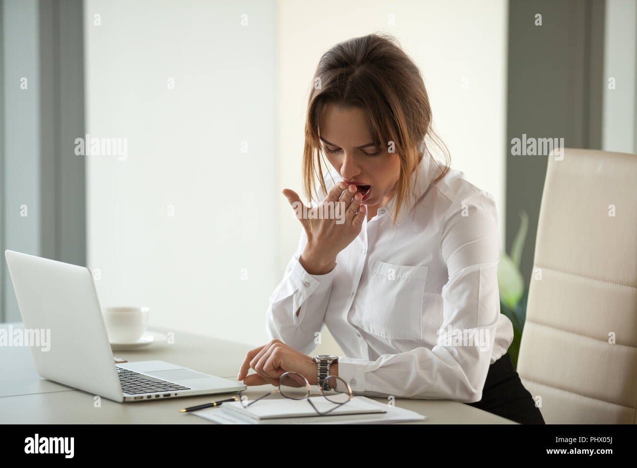 Woman checking clock office hi-res stock photography and images - Alamy