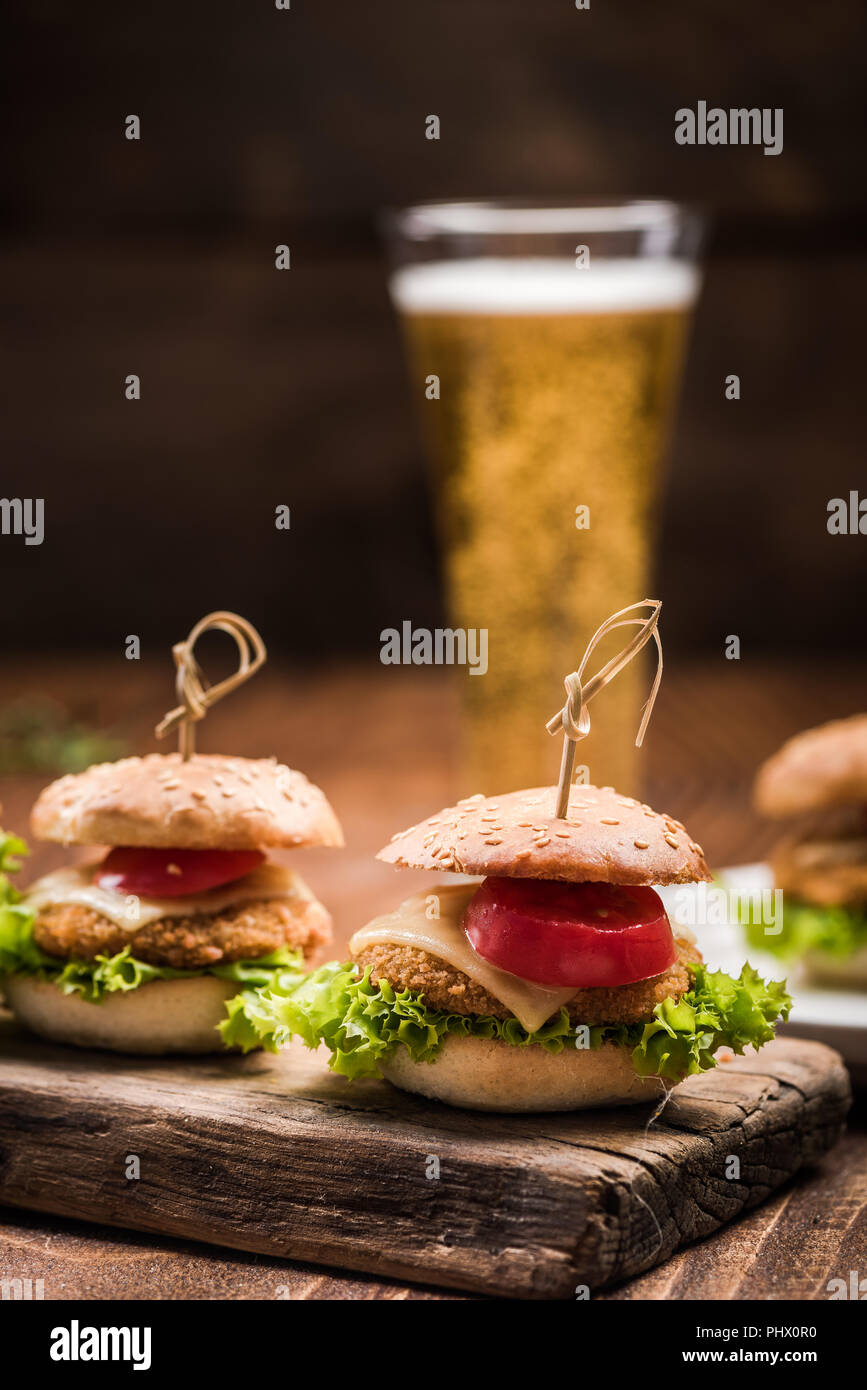 Chicken burgers served with beer in pub Stock Photo - Alamy