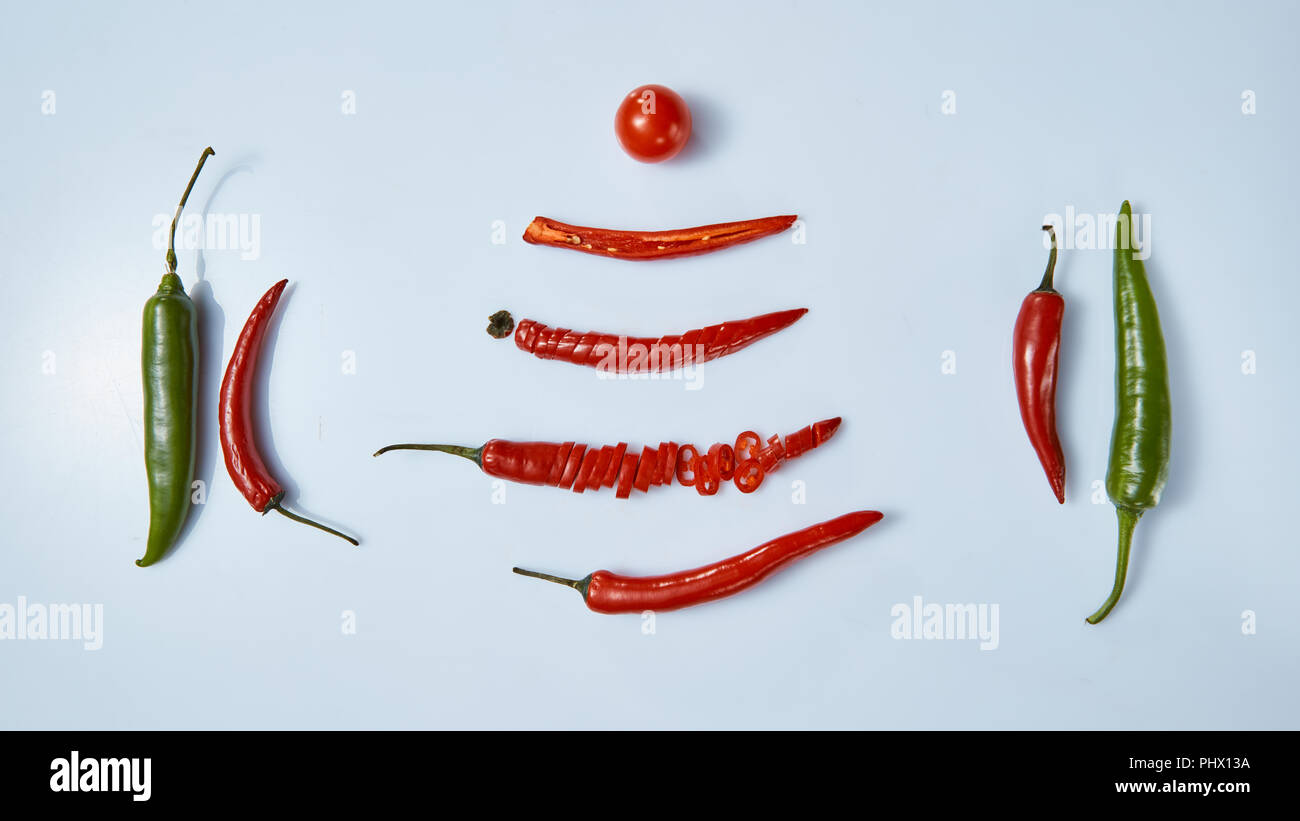 layout of chili peppers and tomato on gray background Stock Photo - Alamy
