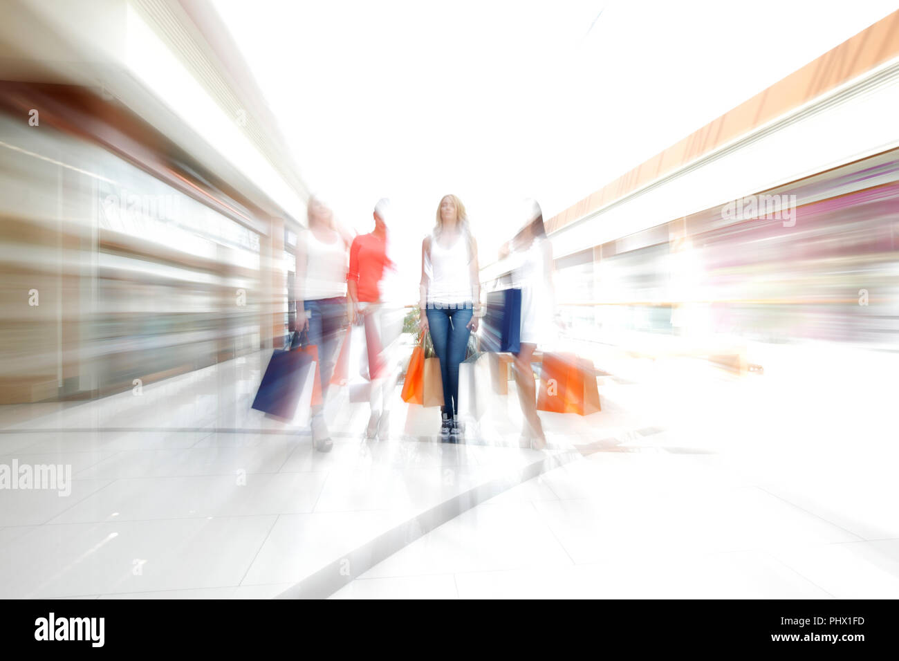 Women walking fast in shopping mall with bags Stock Photo - Alamy