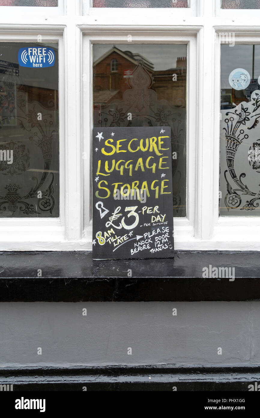 Secure luggage storage advertising sign Stock Photo - Alamy