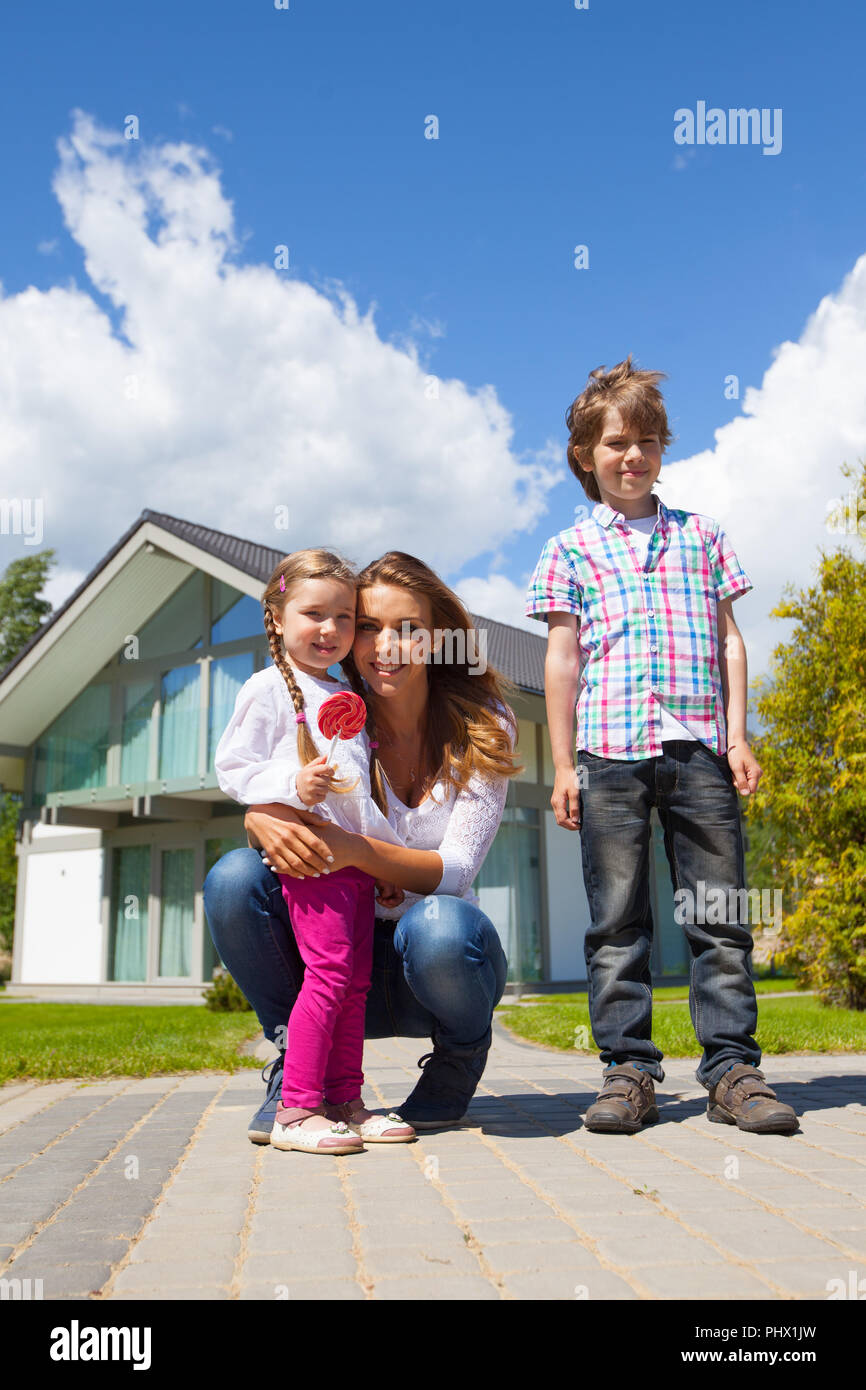 Portrait of happy smiling family of mother and children near their ...