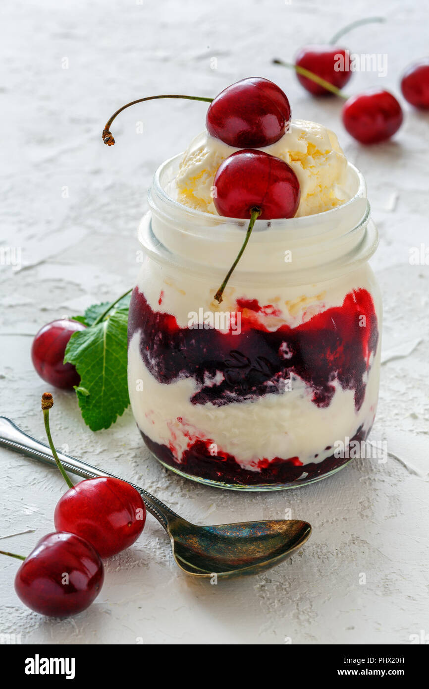 Sundae with sweet cherry in a glass jar Stock Photo - Alamy