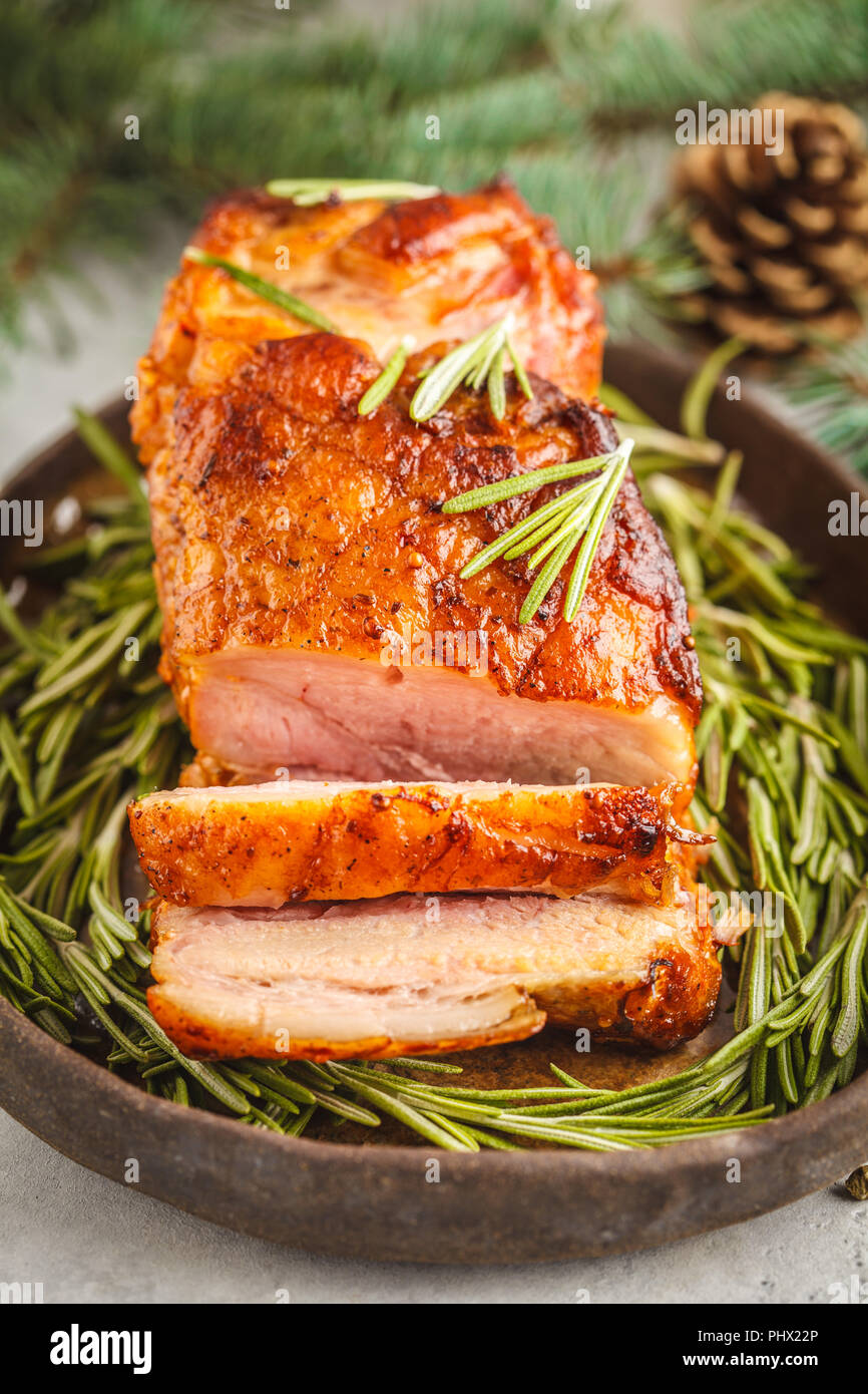Baked Christmas pork (ham) with rosemary. Christmas table, white ...