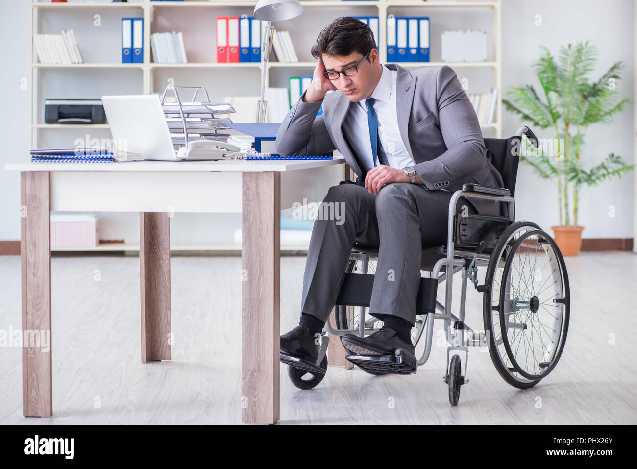 Disabled businessman working in the office Stock Photo - Alamy