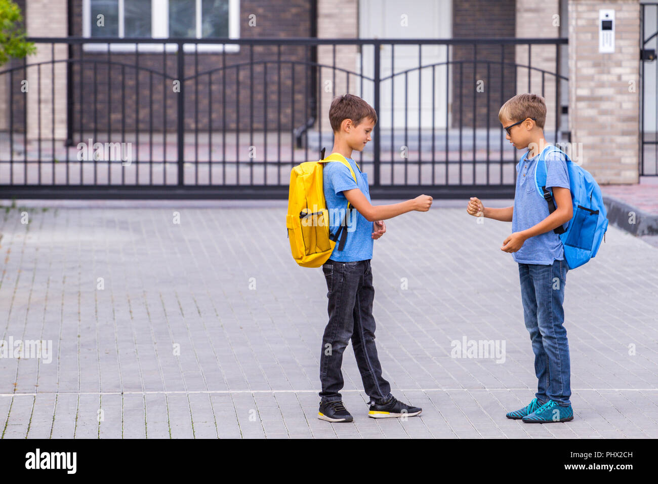 Two boys playing rock paper scissors game after school Stock Photo - Alamy