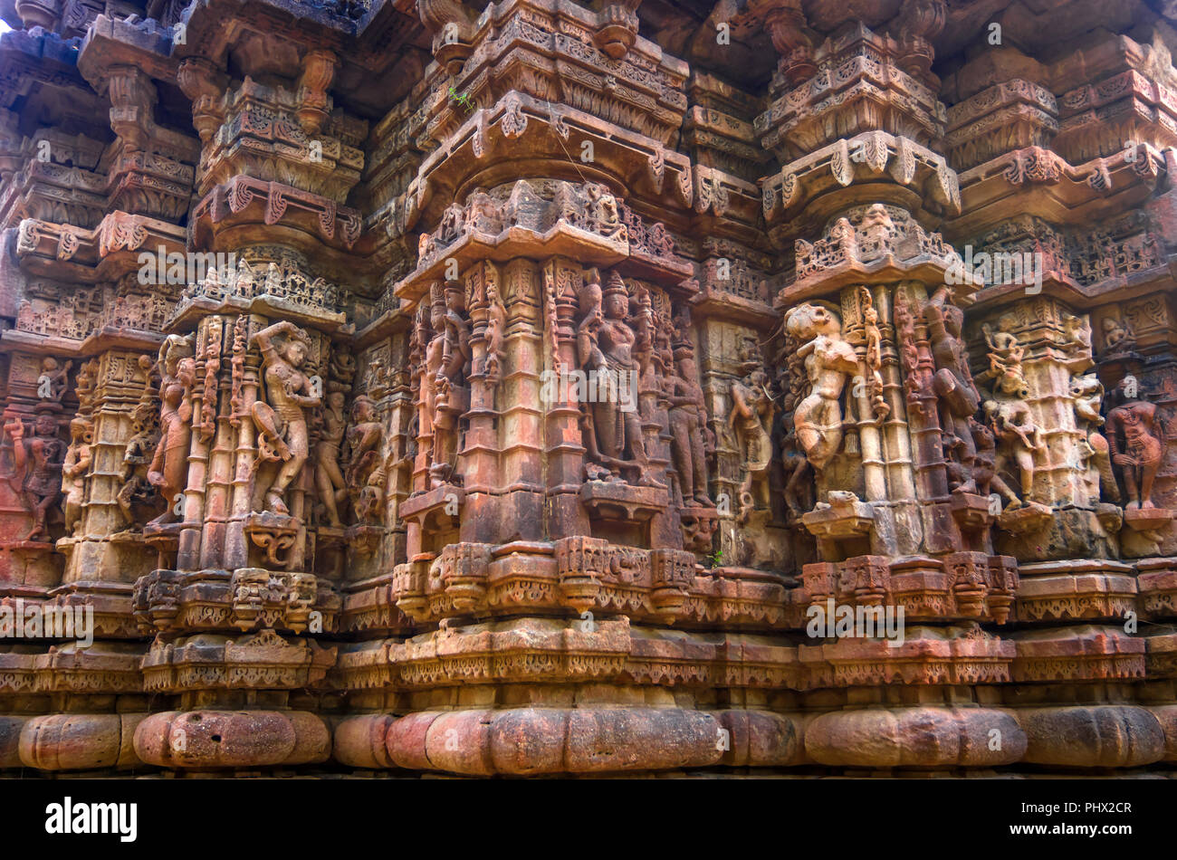 Exterior wall of temple ruins and beautifully carved stone sculpture of ...