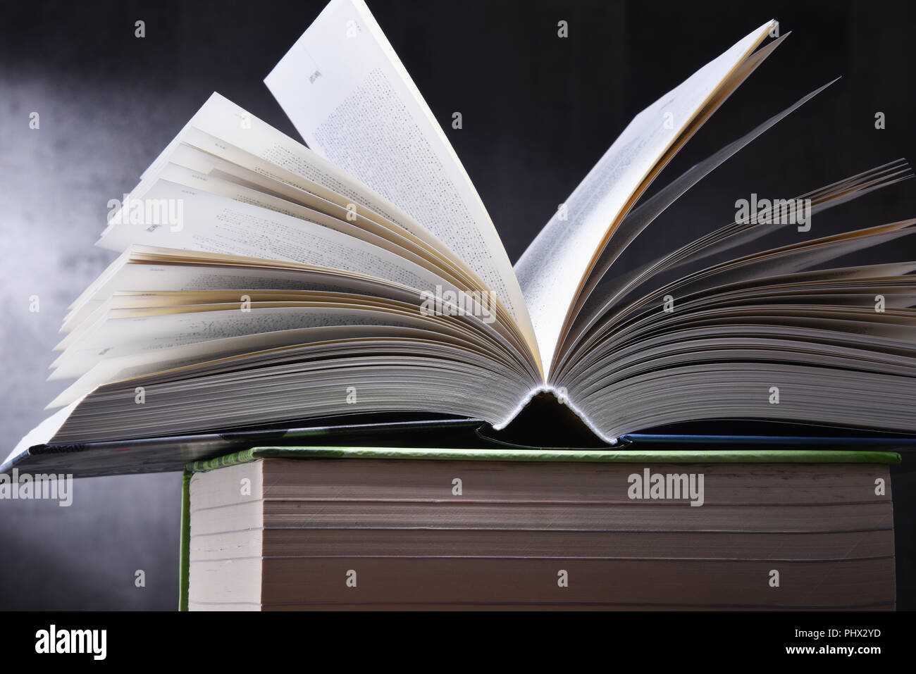 Composition with open book on the table Stock Photo - Alamy