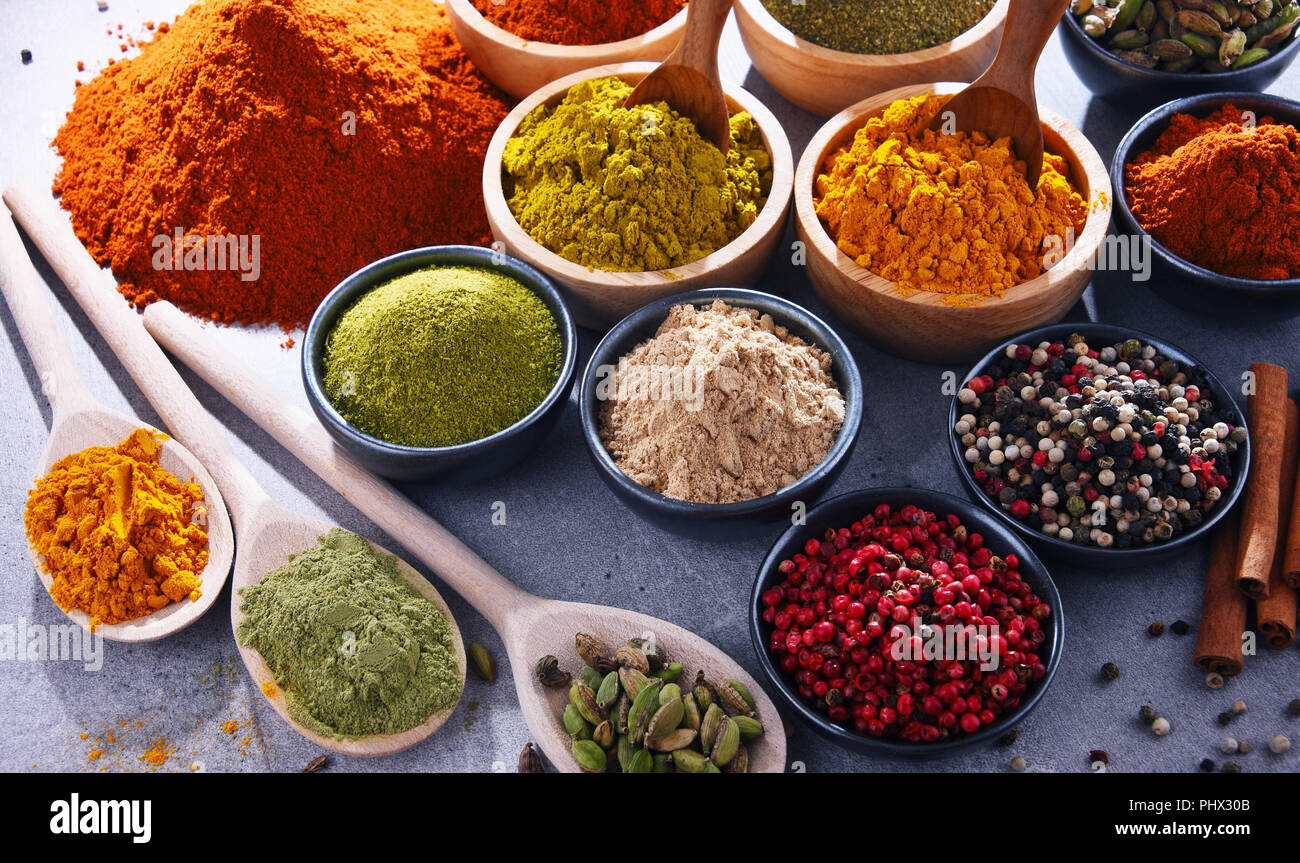 Variety of spices on kitchen table Stock Photo - Alamy