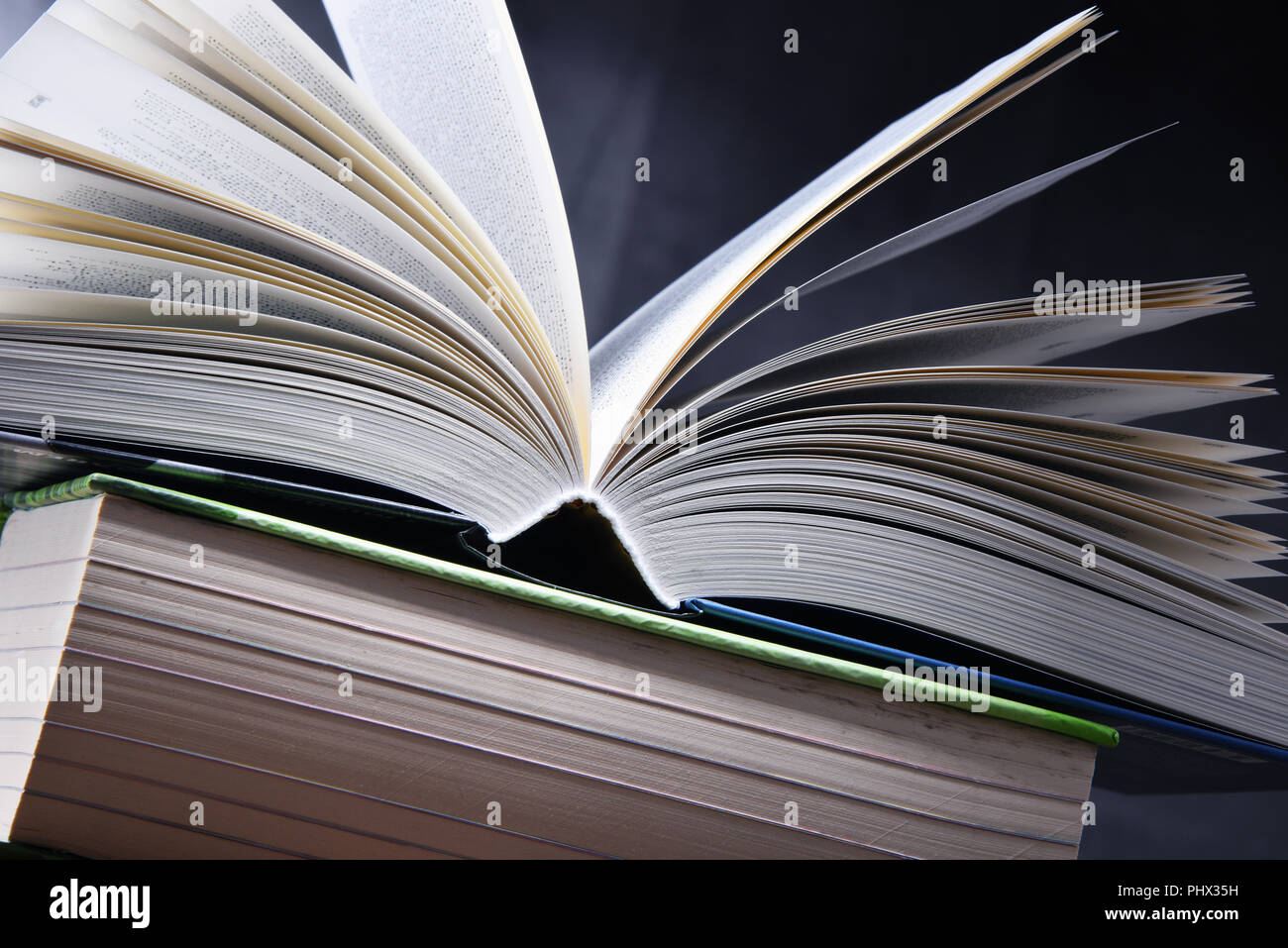 Composition with open book on the table Stock Photo - Alamy