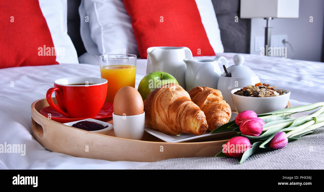 Breakfast on tray in bed in hotel room Stock Photo - Alamy