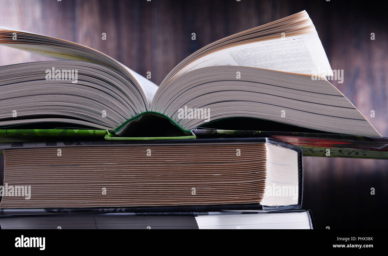 Composition with open book on the table Stock Photo - Alamy