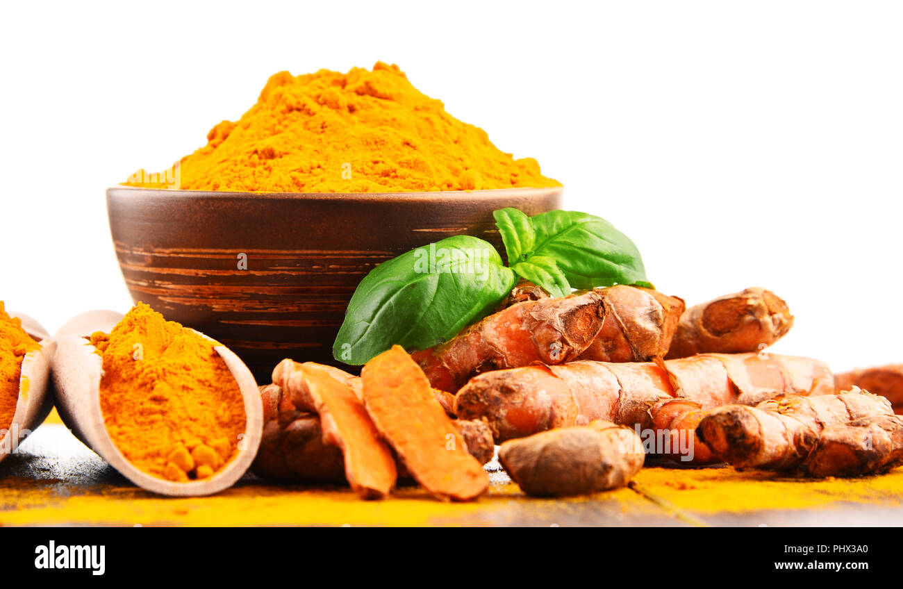 Bowl of turmeric powder over white background Stock Photo - Alamy