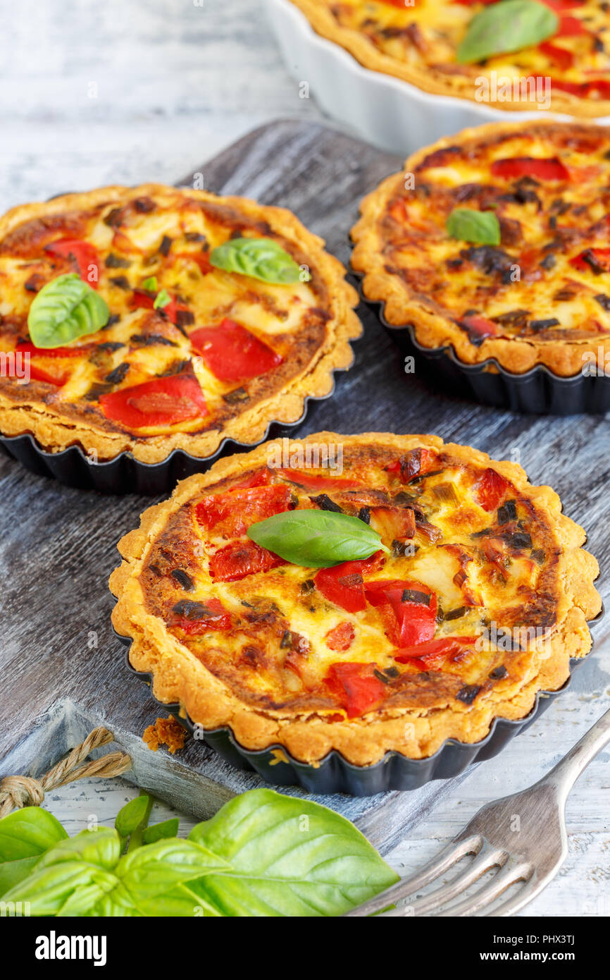 Mini quiche with chicken, onion and sweet pepper Stock Photo - Alamy
