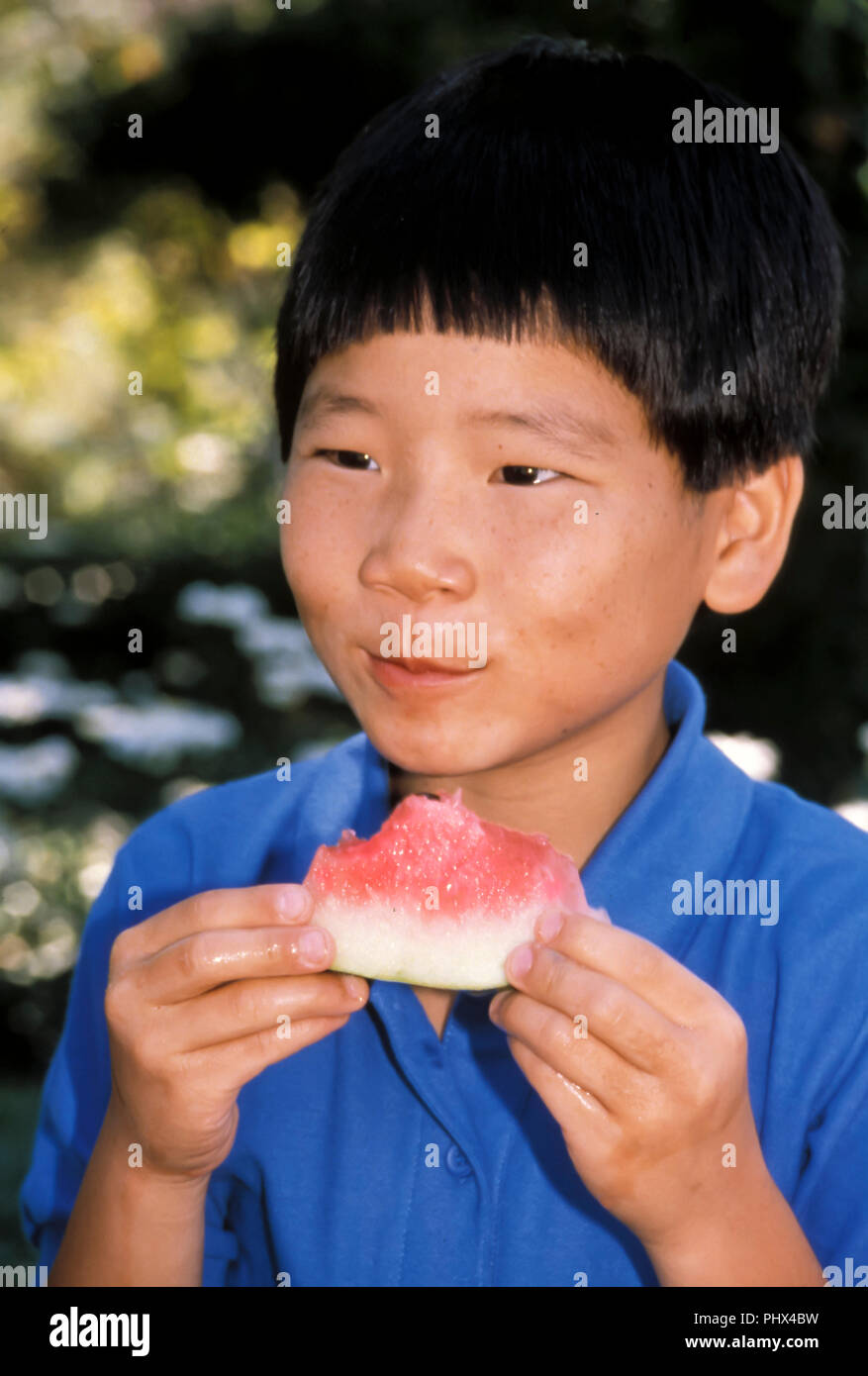 Young Korean boy eating watermelon outside © Myrleen Pearson ..Ferguson ...