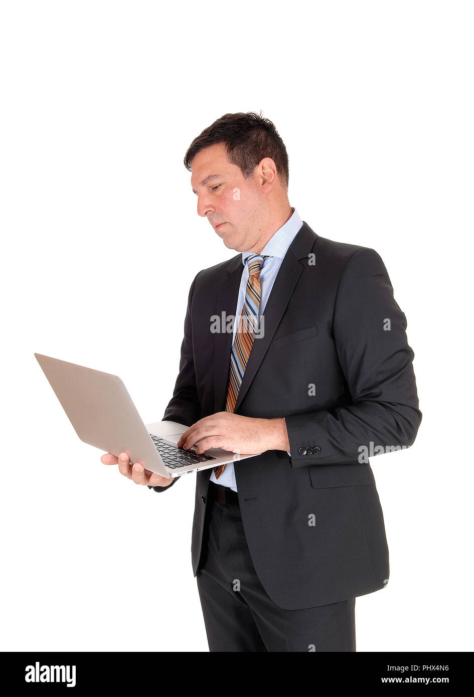 Business man reading on his laptop and standing Stock Photo - Alamy