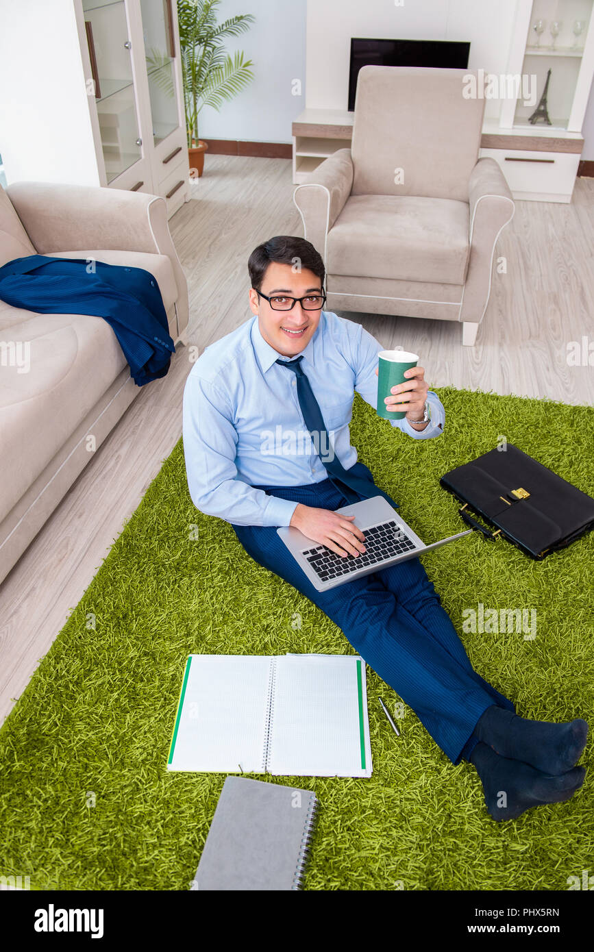 Businessman taking work home and working overtime Stock Photo - Alamy