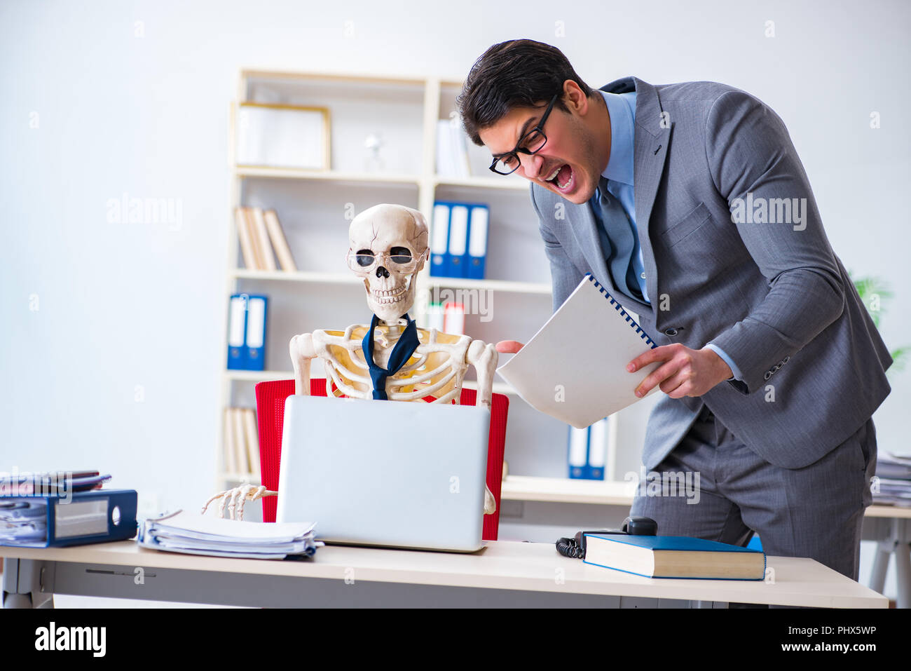 Angry boss yelling at his skeleton employee Stock Photo - Alamy