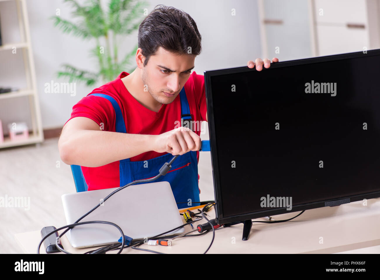 Professional repair engineer repairing broken tv Stock Photo - Alamy