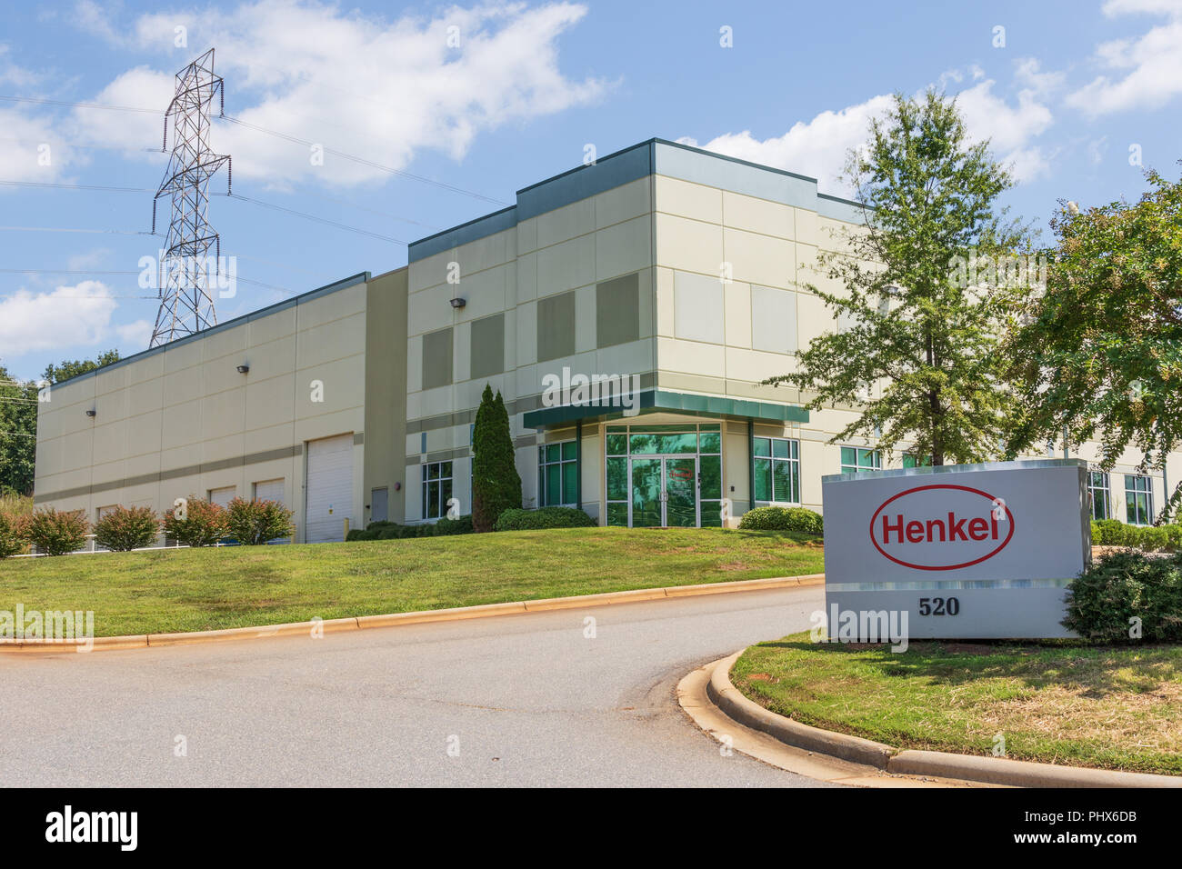 LINCOLNTON, NC, USA-8/25/18: Road sign and warehouse for Henkel Company ...