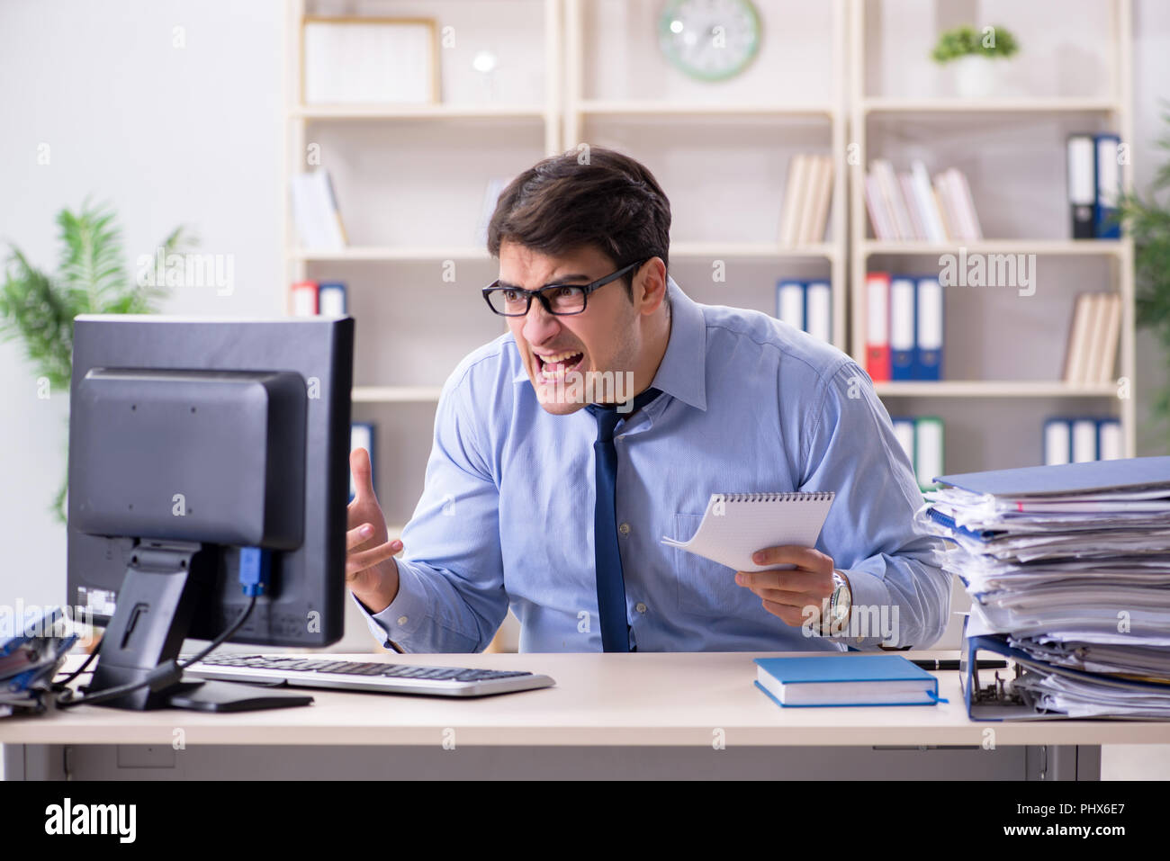 Tired businessman with too much paperwork Stock Photo - Alamy