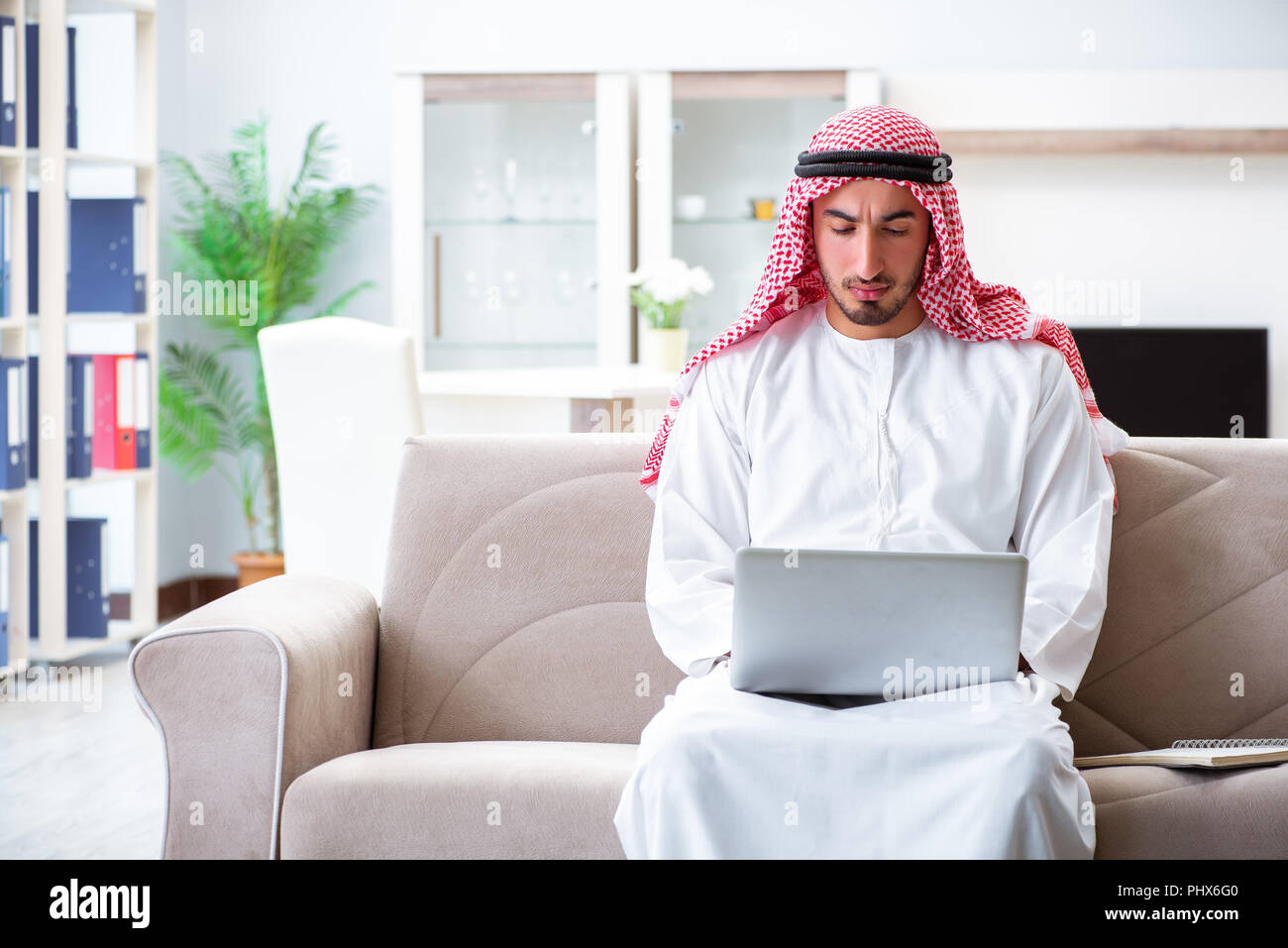 Arab man working at home on his work Stock Photo - Alamy