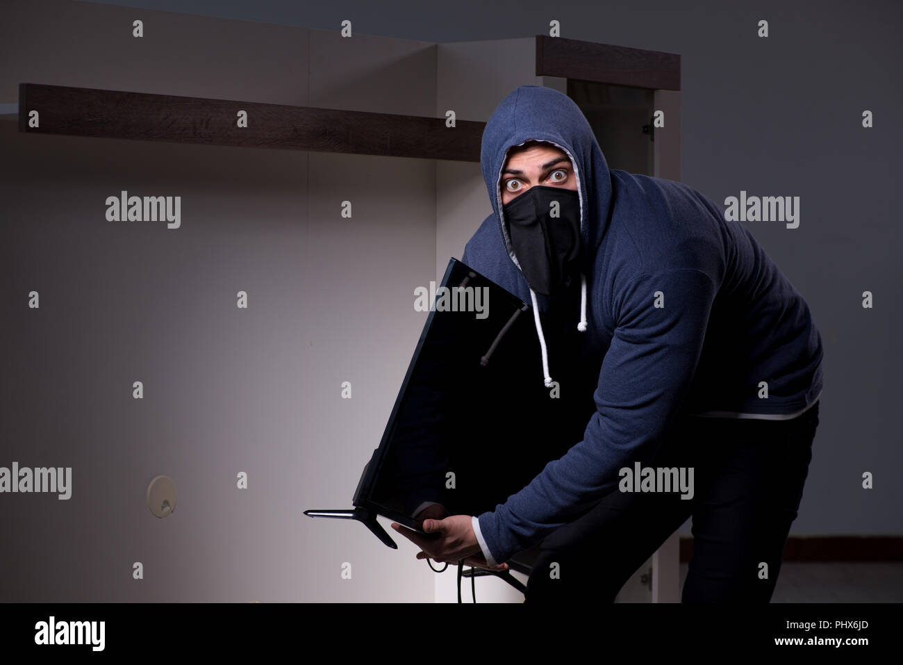 Burglar thief stealing tv from apartment house Stock Photo - Alamy