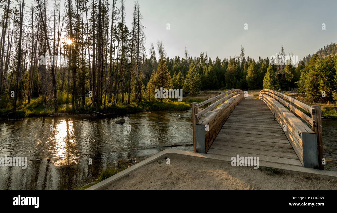 Sunset over a wild river in Idaho near a fancy foot bridge Stock Photo ...