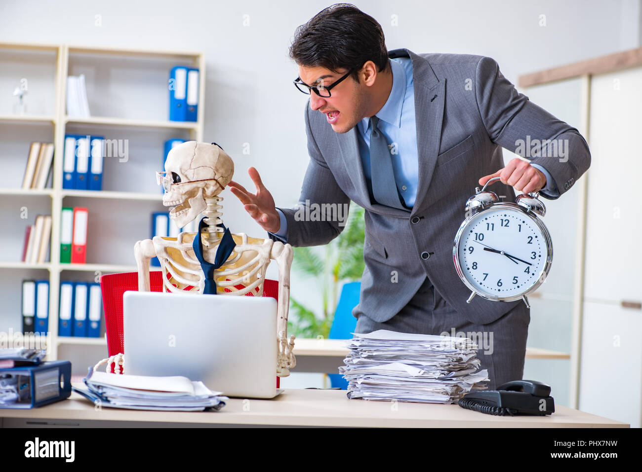Angry boss yelling at his skeleton employee Stock Photo - Alamy