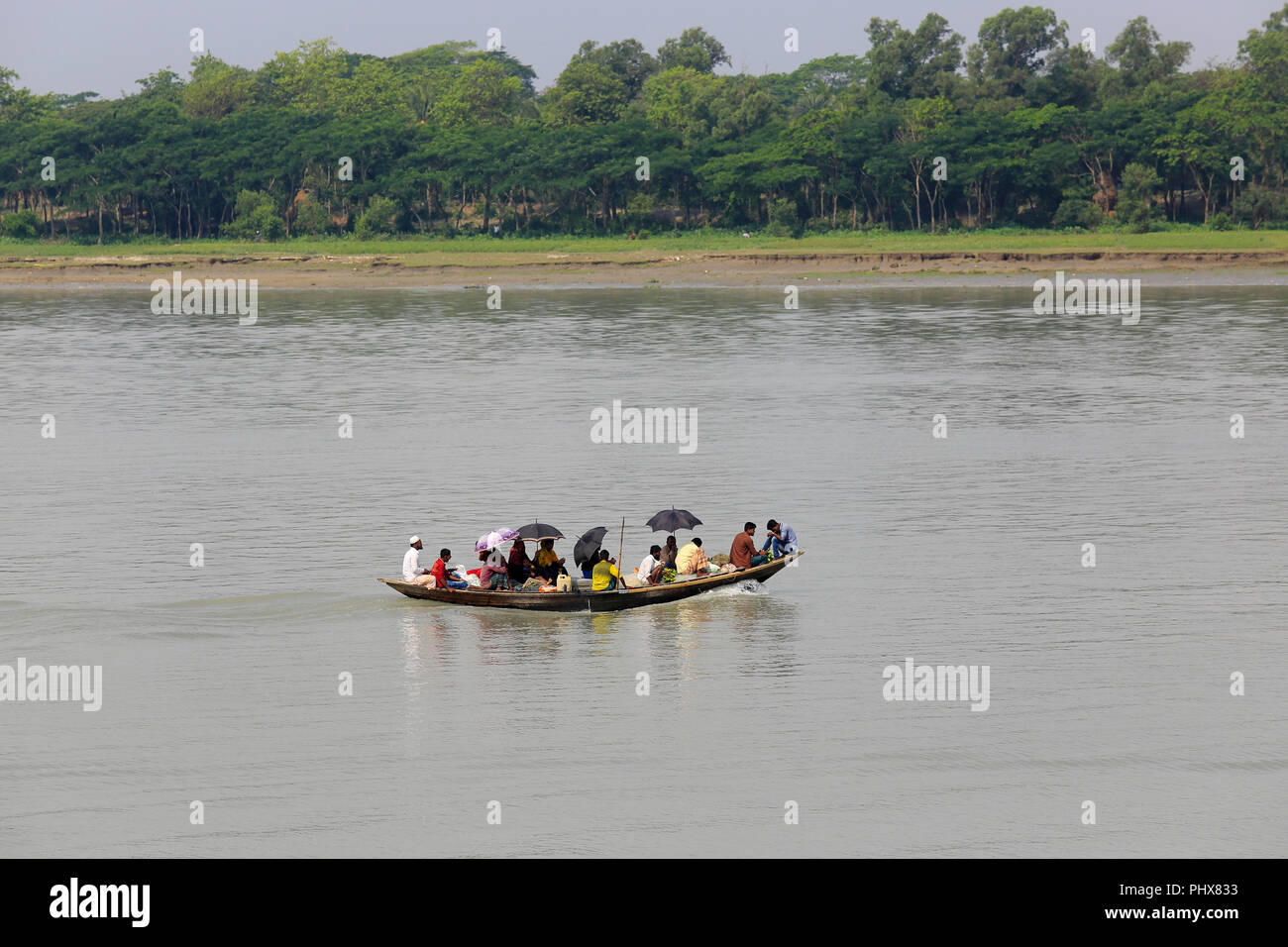 Rural people travel on a small boat through Tetulia River, Patuakhali ...