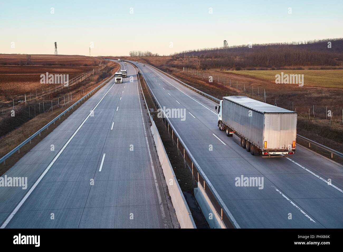 Highway with cargo trucks Stock Photo - Alamy